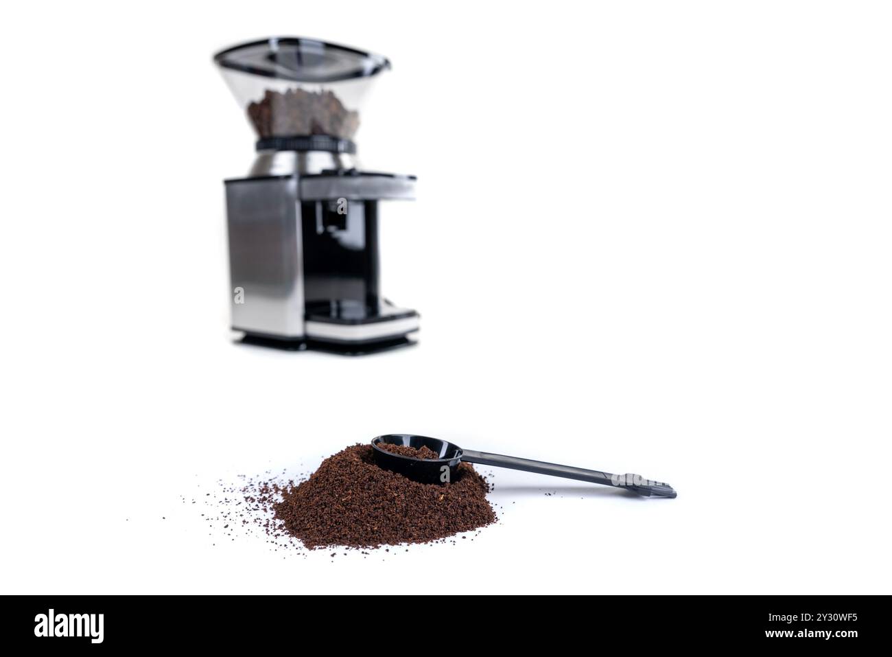 Espresso bean coffee grinder with beans and grounds under a black scoop ...