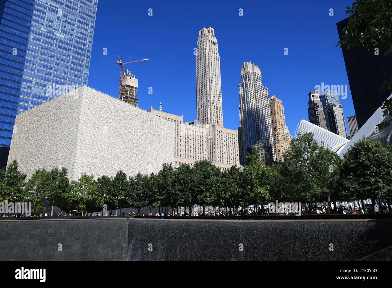 Tourists visit one of the two reflecting pools at the National ...