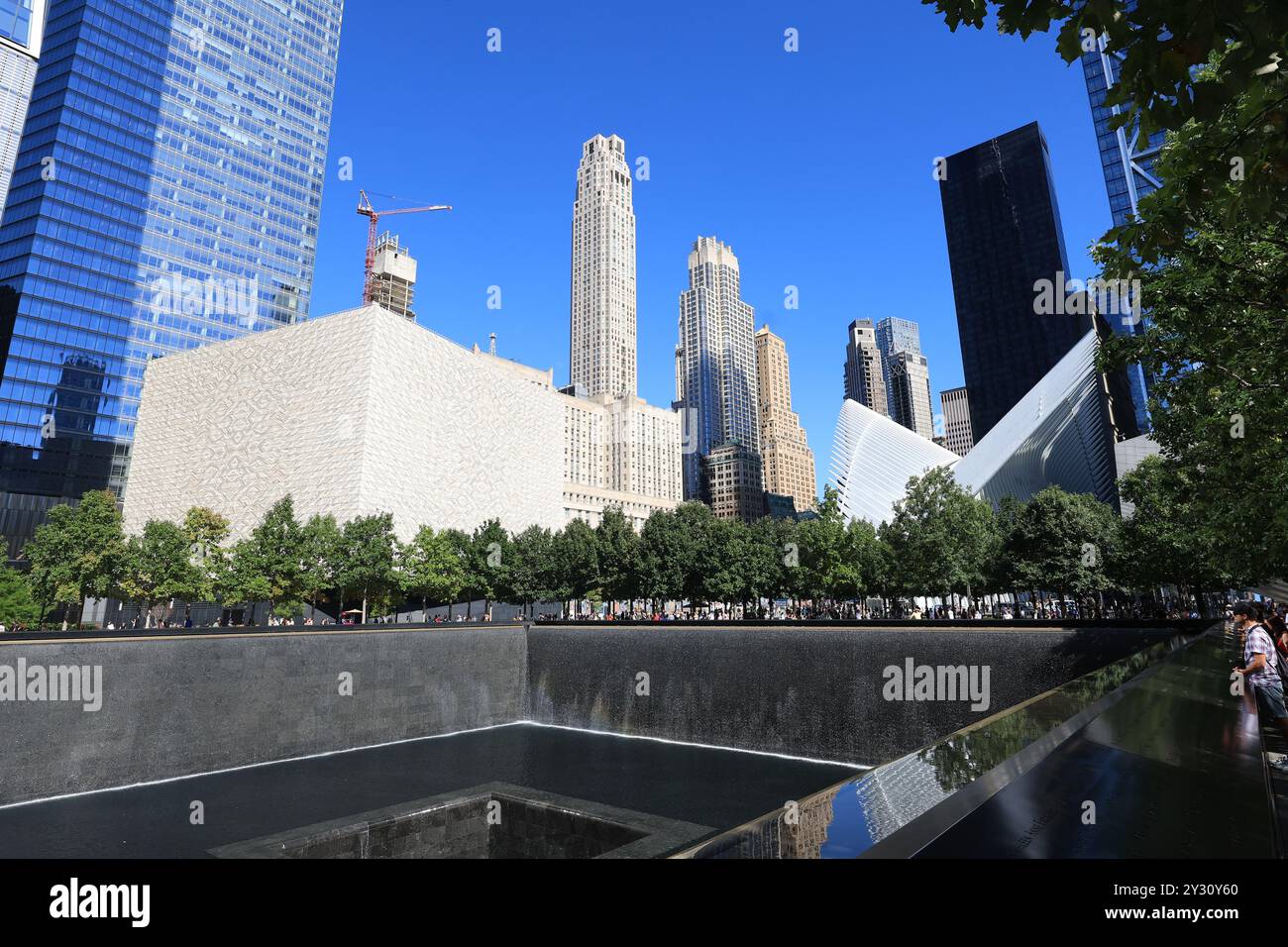 Tourists visit one of the two reflecting pools at the National ...