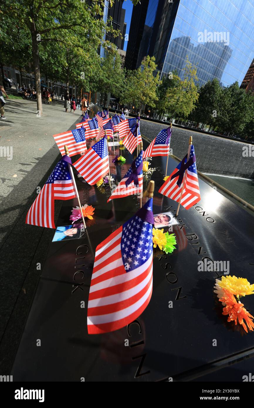 Visitors place flags and take photos at the South Pool, one of two ...