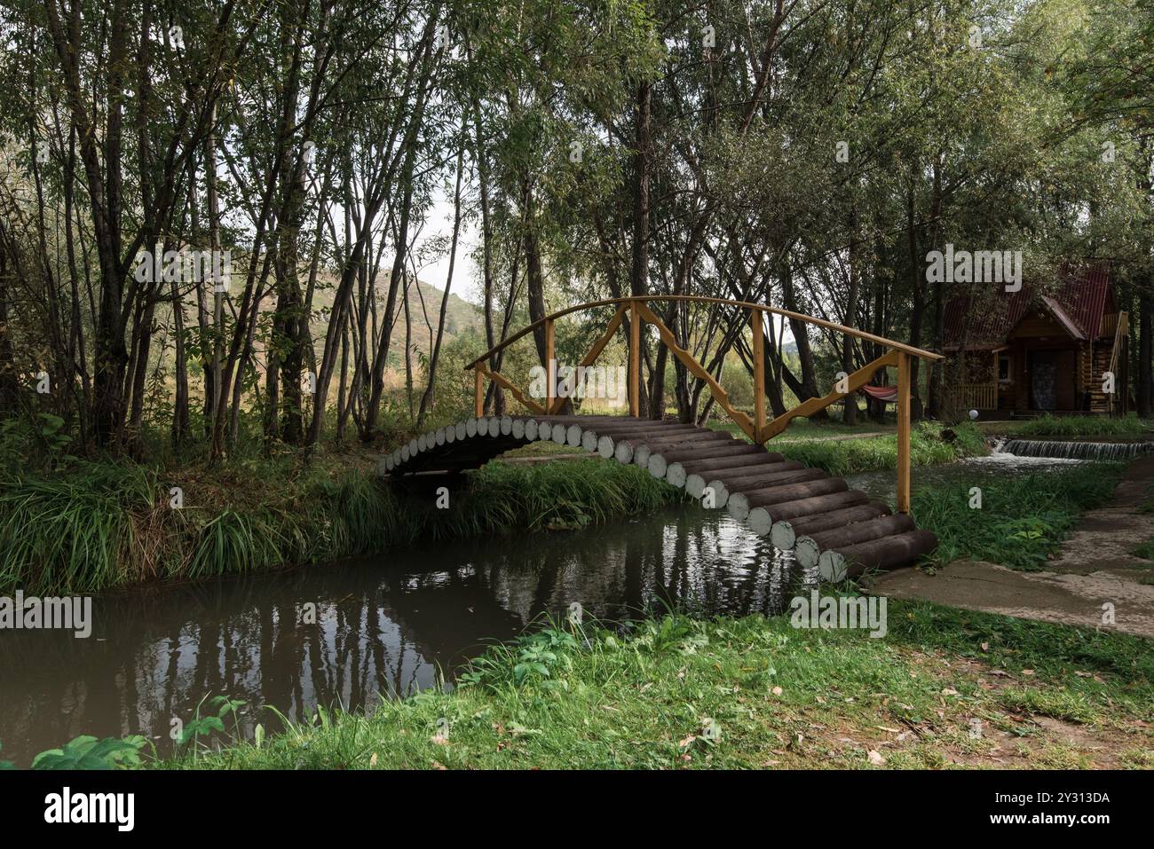 Wooden bridge in a beautiful garden, summertime Stock Photo - Alamy