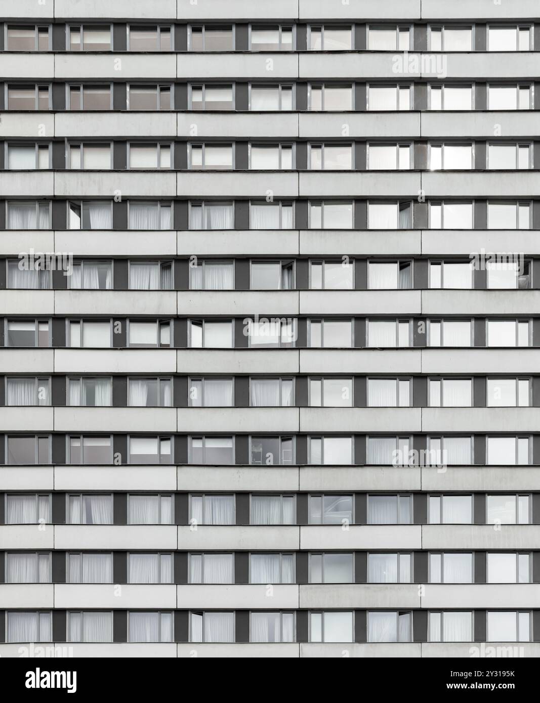 White wall of an office building with windows in rows. Abstract ...