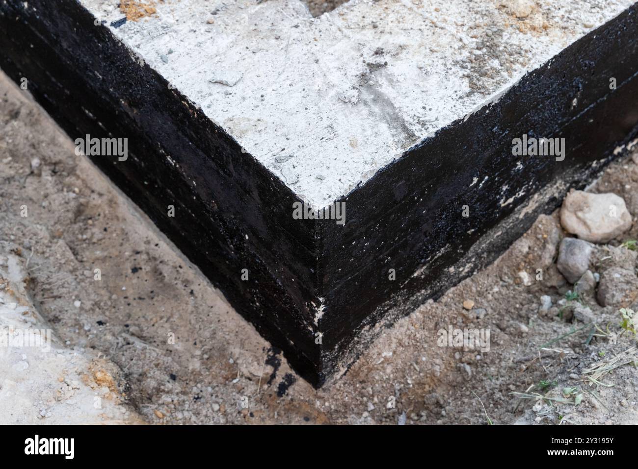 Corner of a strip foundation made of reinforced concrete is covered ...