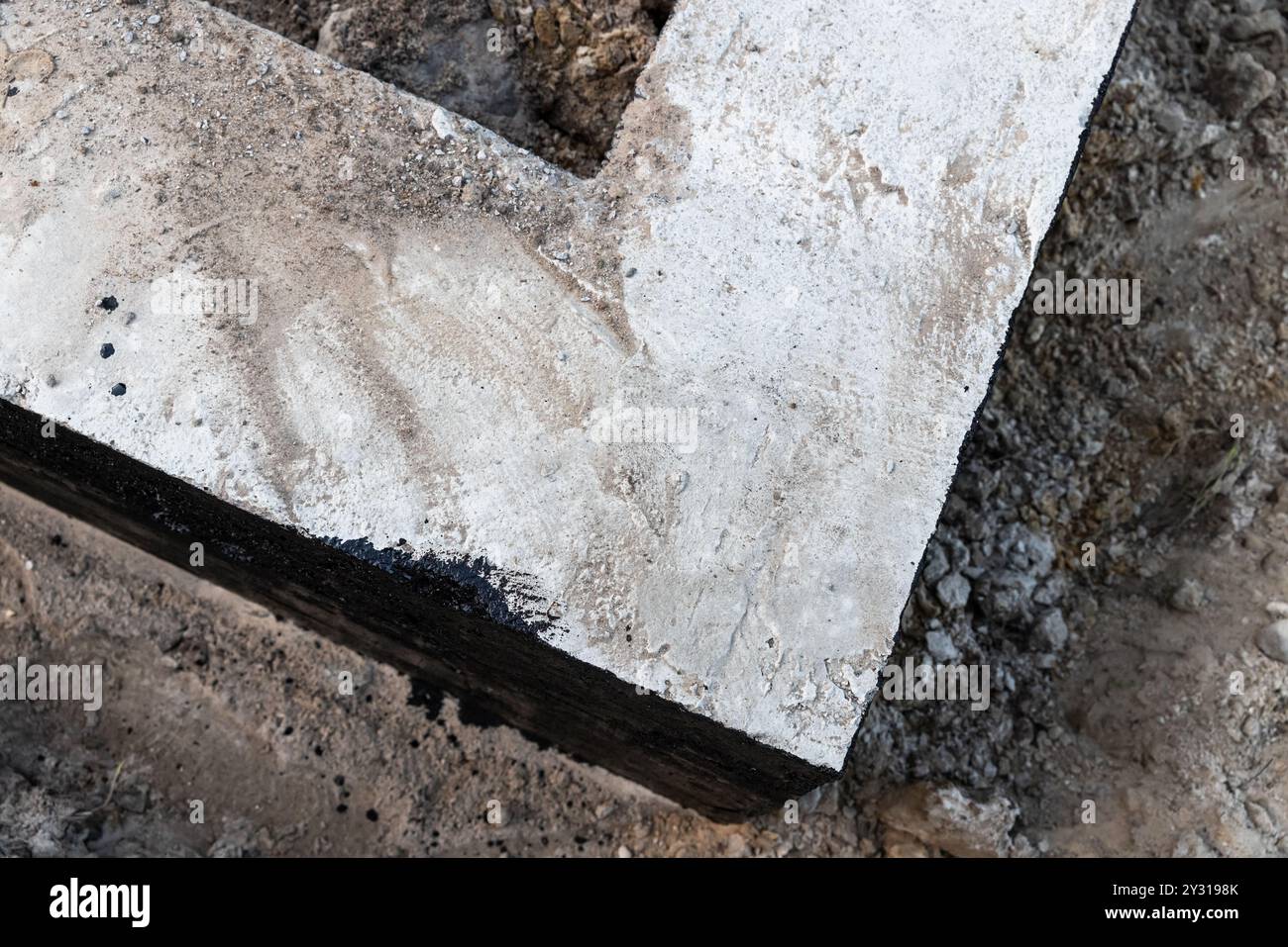 Corner of a strip foundation made of reinforced concrete is covered ...