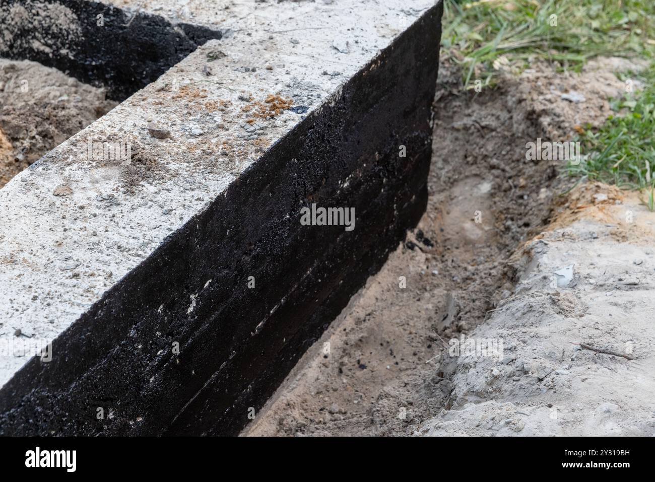 Strip foundation made of reinforced concrete is covered with a ...