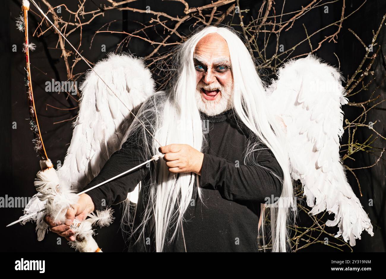 Art photo of a Angelic man. Senior man posing with angel wings. Man ...