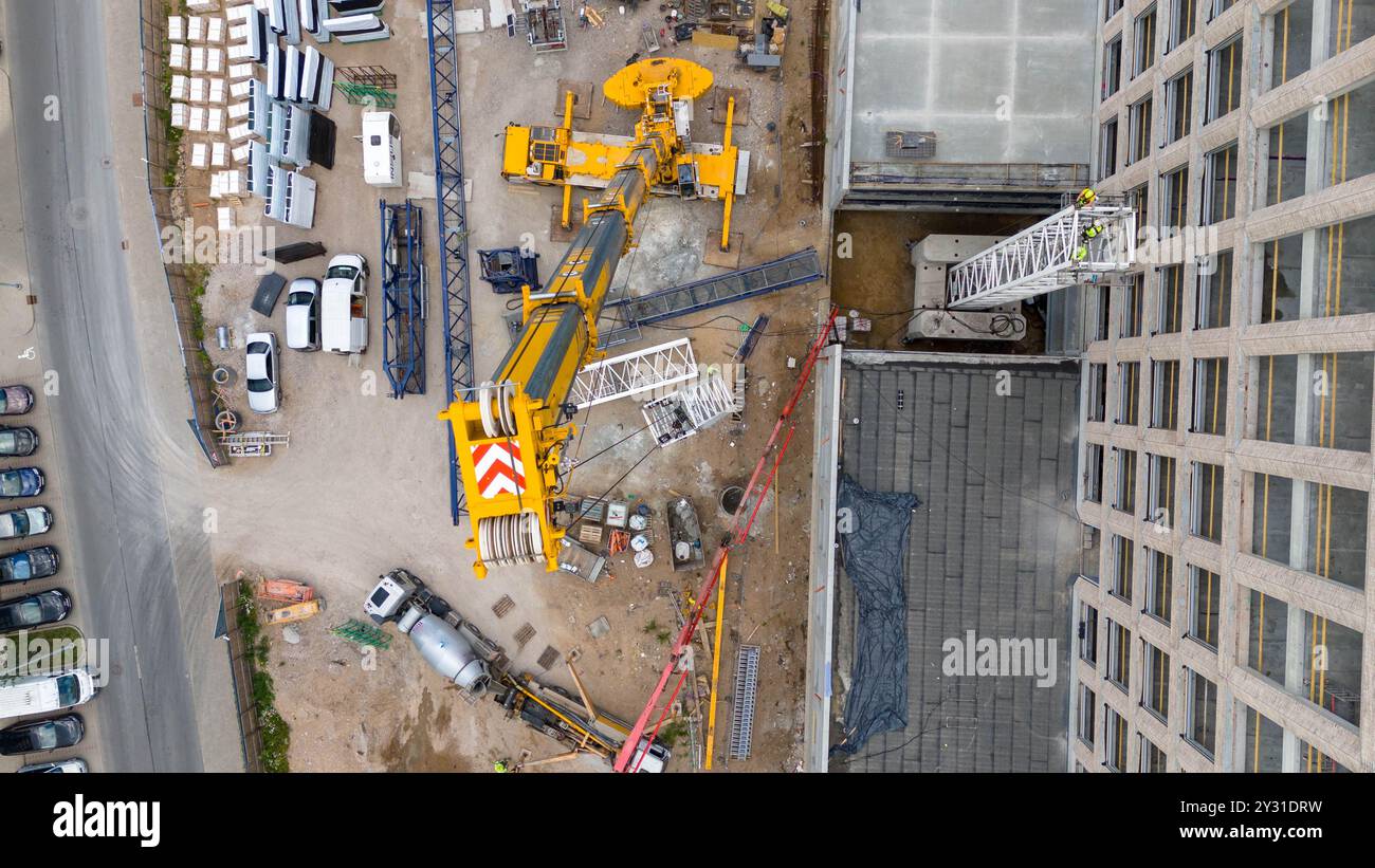 Aerial view of a construction site featuring cranes, construction ...