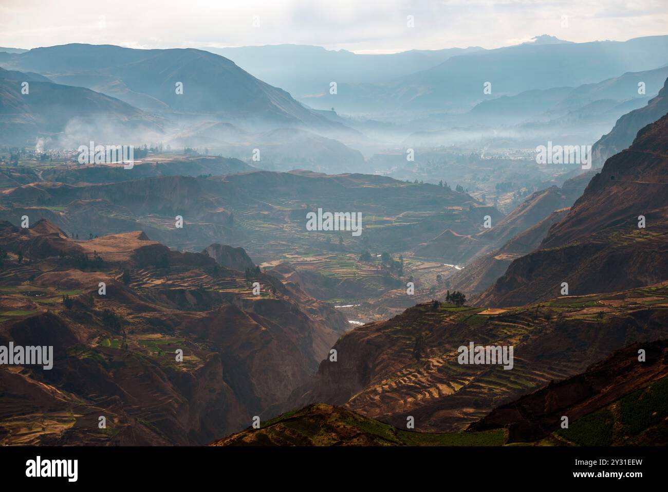 mountain valley with many terraced fields by early morning in Peru ...
