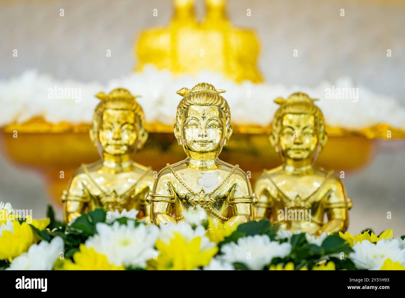 Portrait of three Golden boy Kumanthong top altar with flower ...