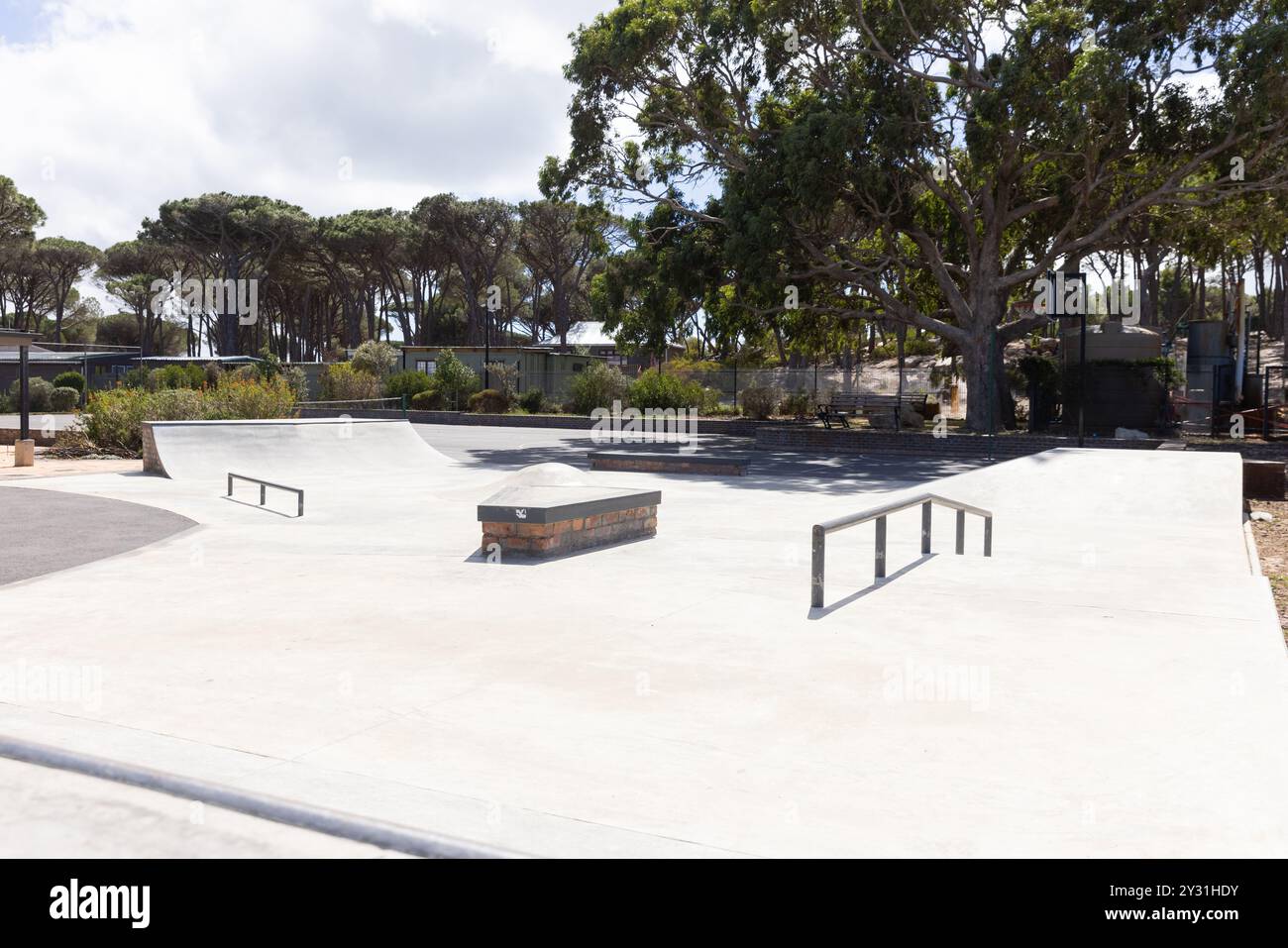 Outdoors, Empty skate park with ramps and rails surrounded by trees and ...