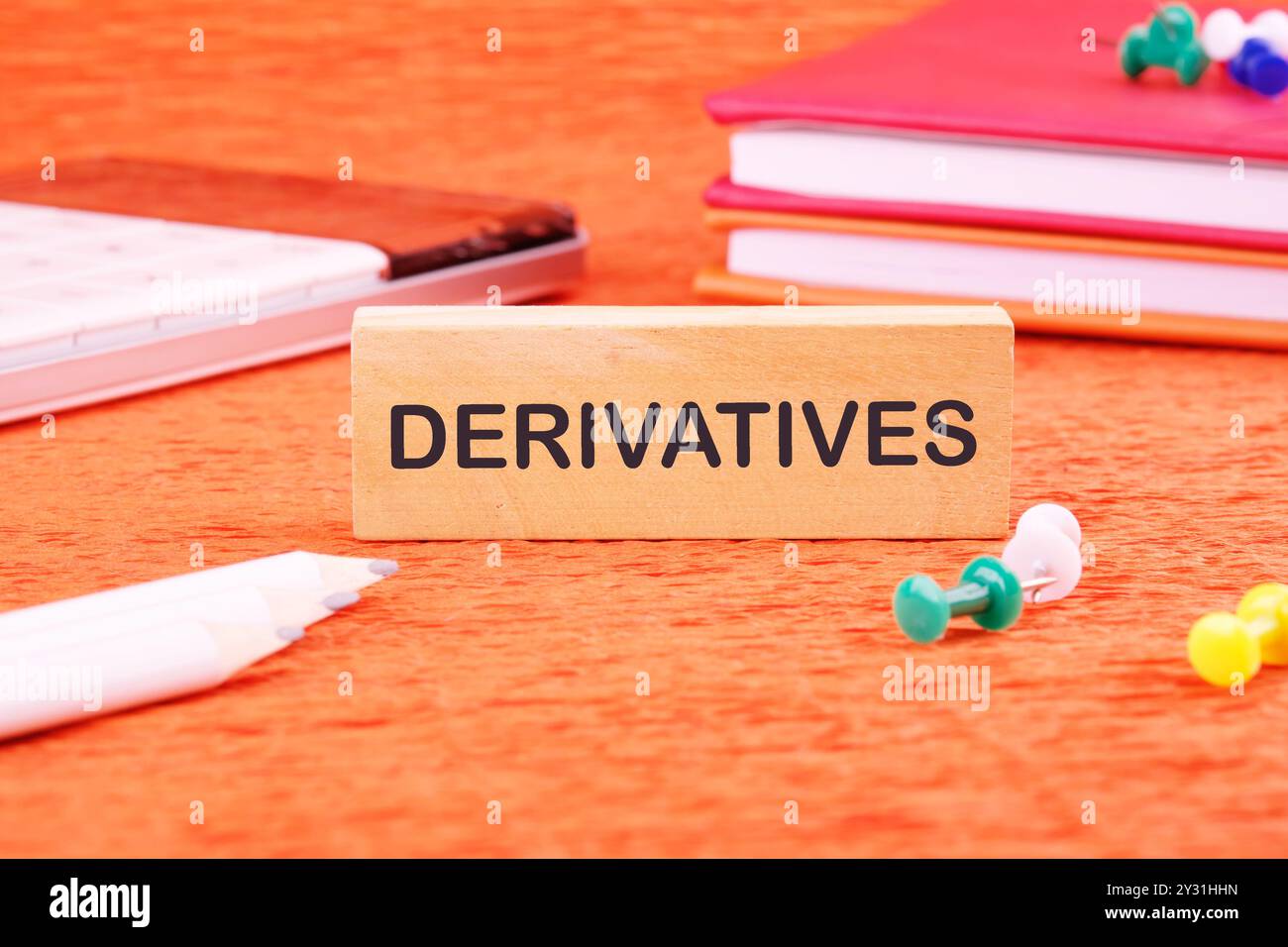Derivatives word written on a wooden bar in front of an orange ...