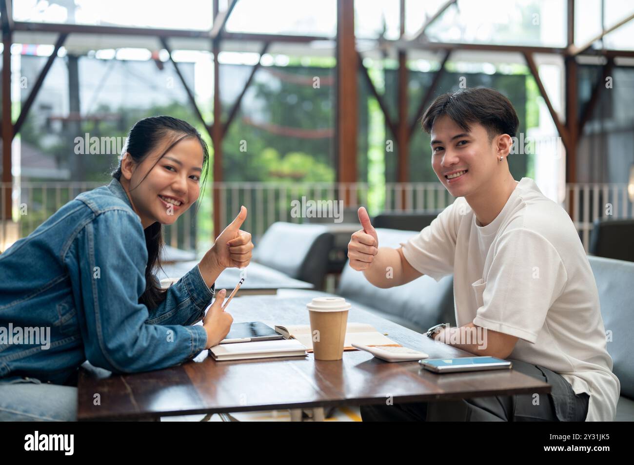 Two positive, happy young Asian college students, a male and a female ...