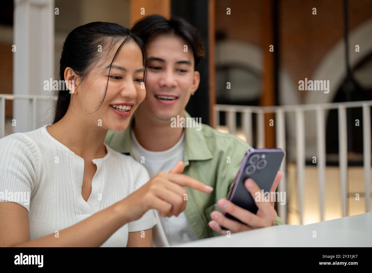A happy, lovely young Asian couple, boyfriend and girlfriend, are ...