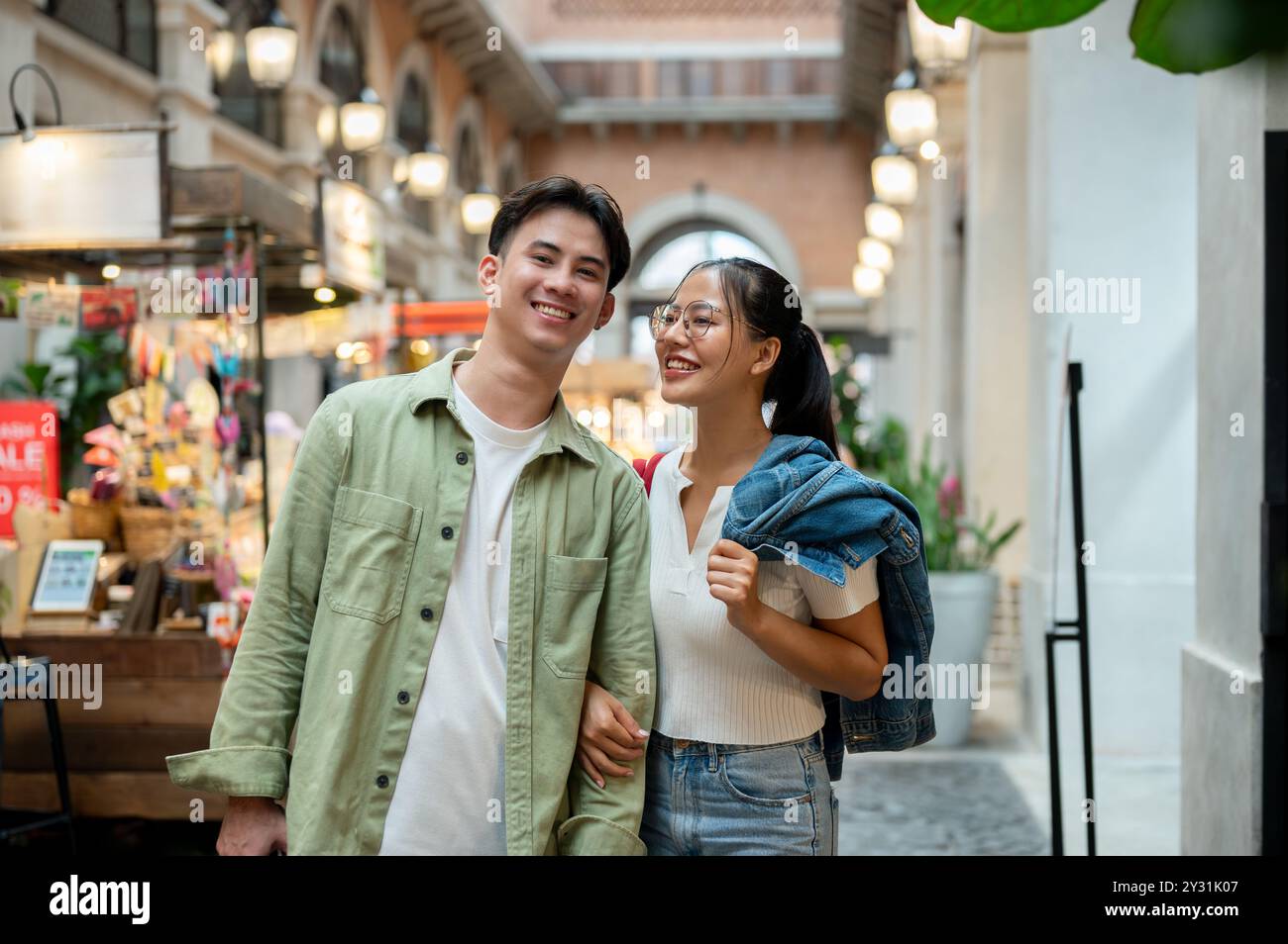 A lovely, happy young Asian couple, boyfriend and girlfriend, are ...
