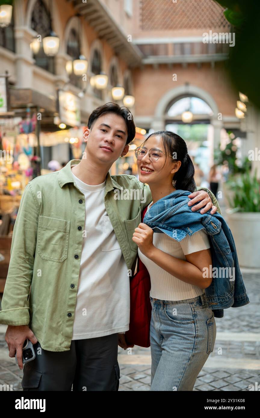 A lovely, happy young Asian couple, boyfriend and girlfriend, are ...