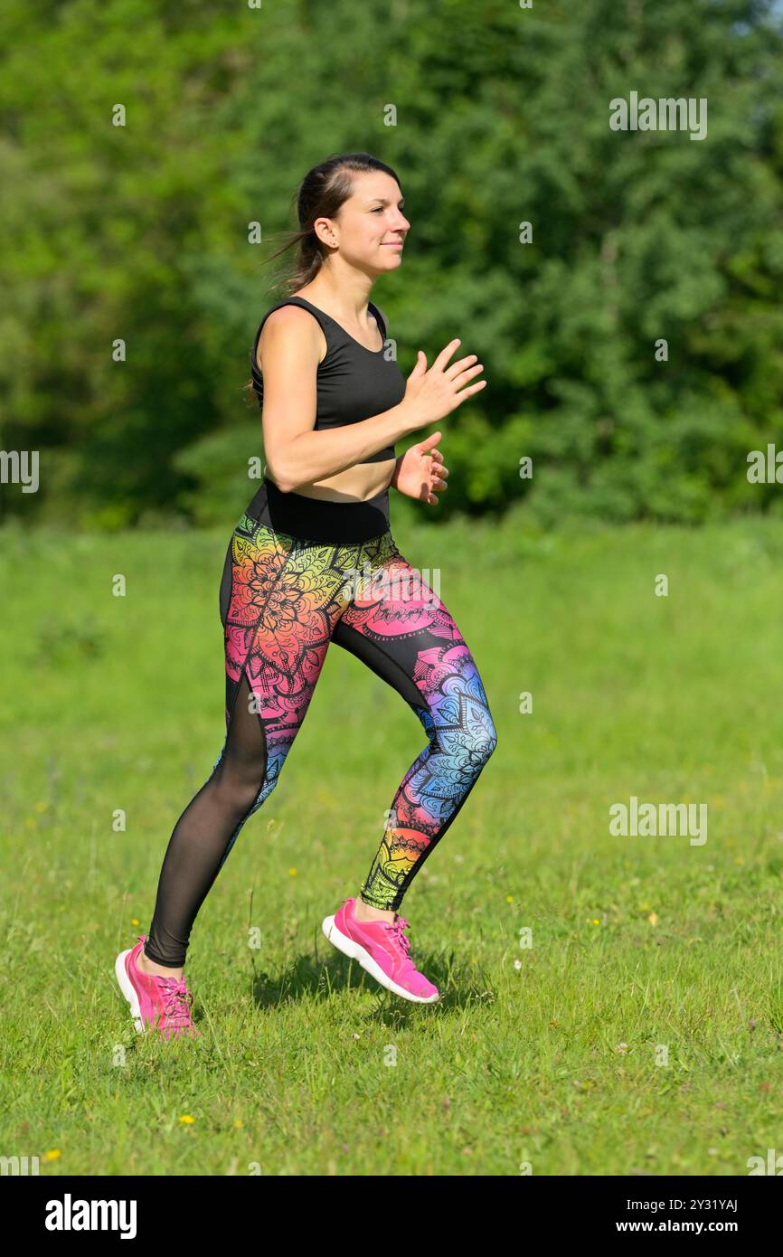 Young woman runs in summer hi-res stock photography and images - Alamy