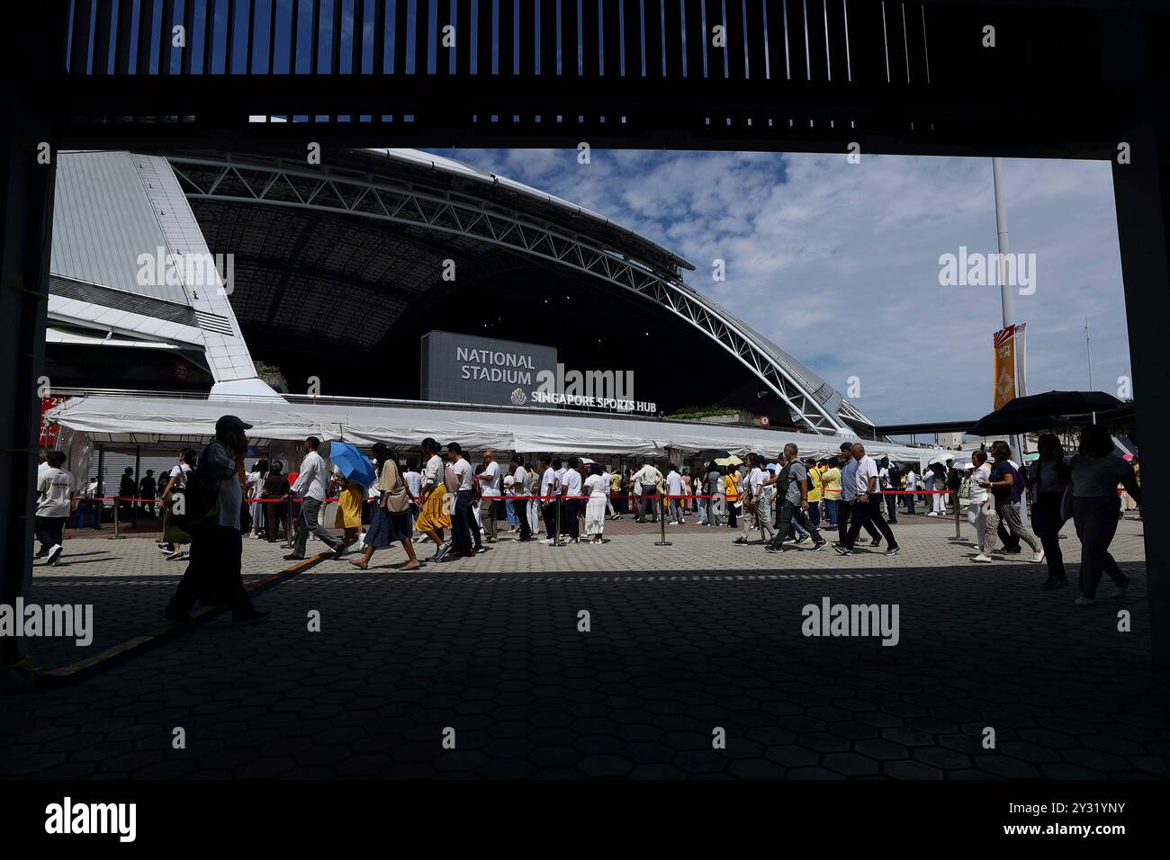 People queue to enter the National Stadium ahead of Pope Francis' mass ...