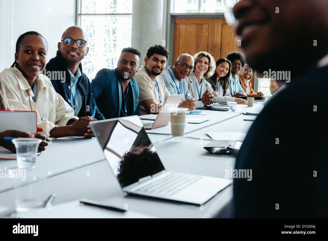 Diverse group of colleagues smiling and participating in a business ...