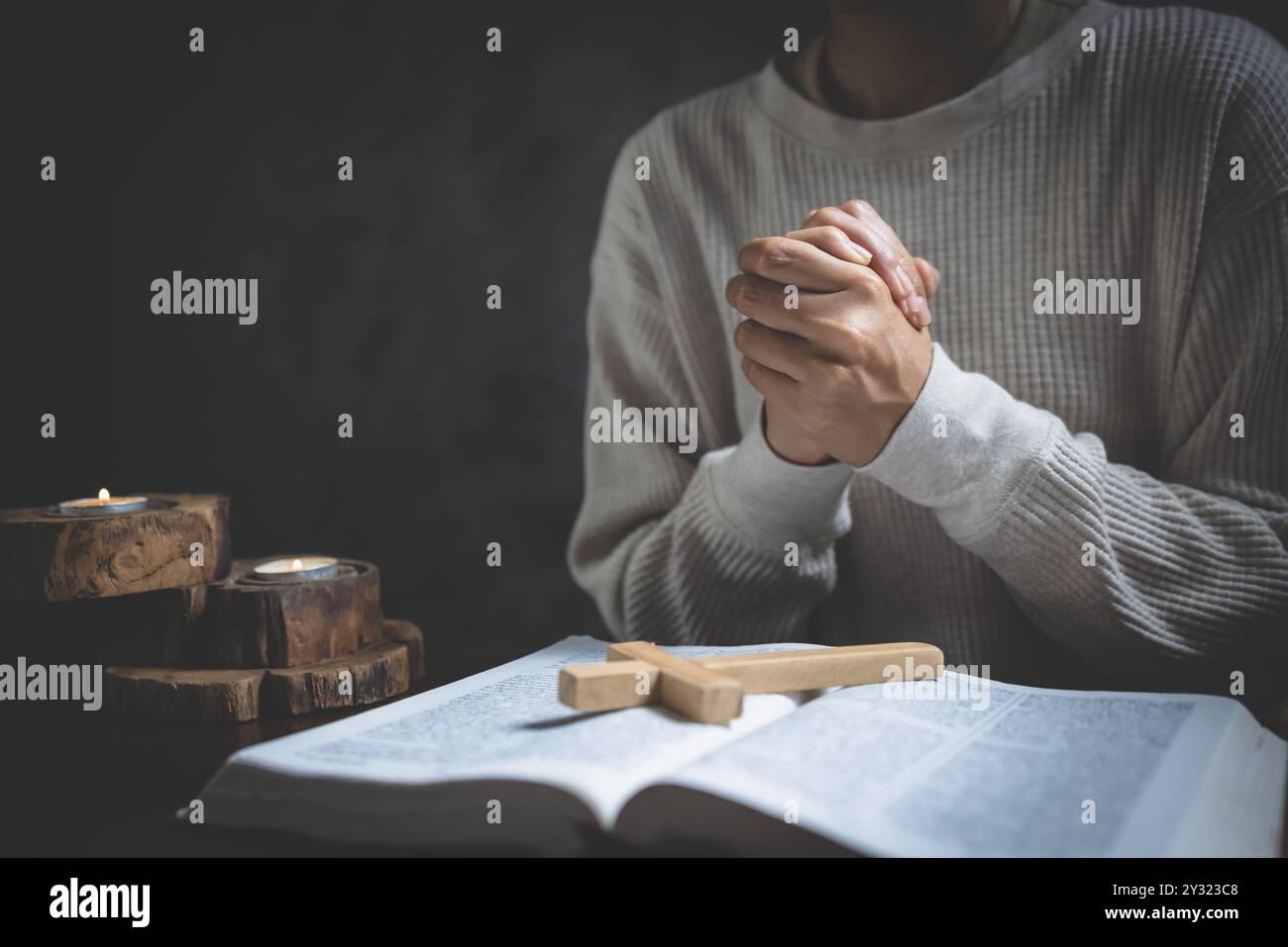 woman praying on holy bible in the morning. woman hand with Bible praying. Hands folded in ...
