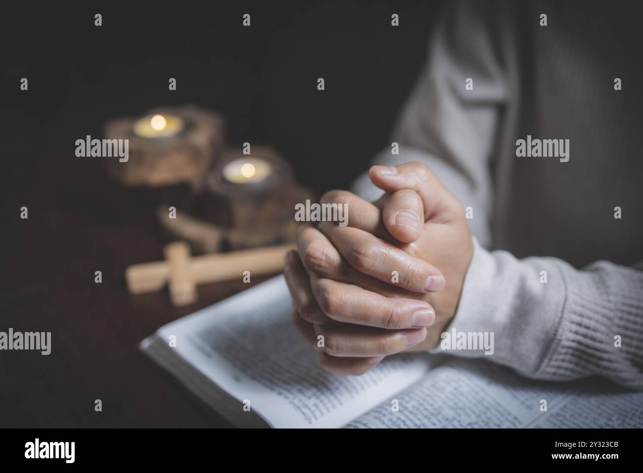 woman praying on holy bible in the morning. woman hand with Bible praying. Hands folded in ...