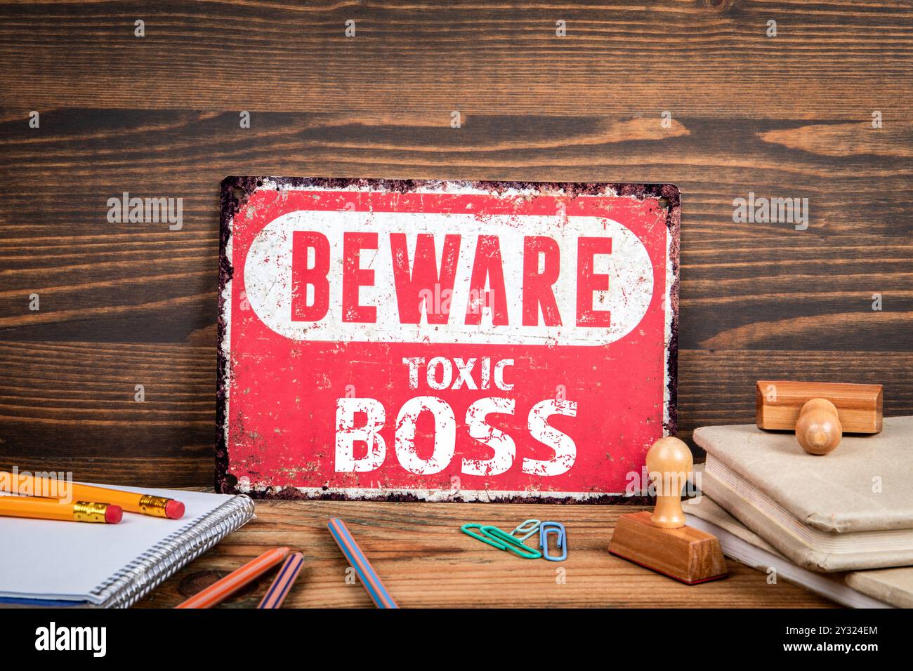 Toxic Boss. Beware sign with text on a wooden texture office table ...