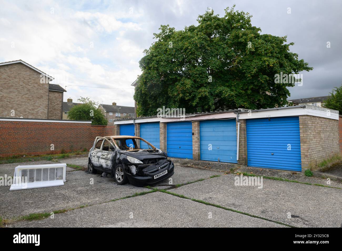 A burnt-out car left at a garage block off Saint Michael's Road ...