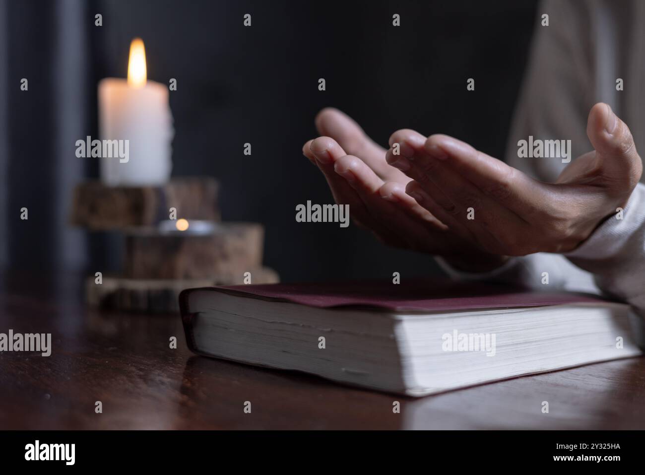 Woman praying while holding Bible and cross, Pray in the Morning ...