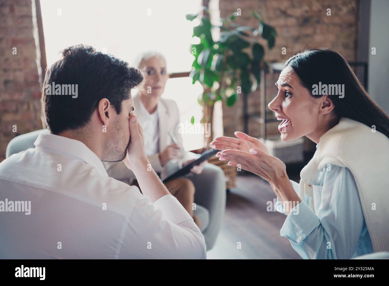 Photo of young couple argument shout psychotherapist office mature ...