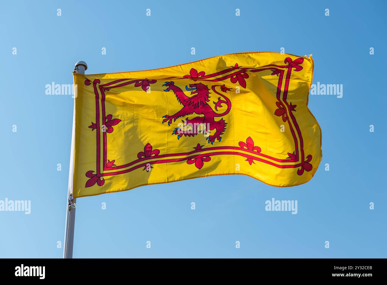Royal Banner of the Royal Arms of Scotland on blue sky background on a ...