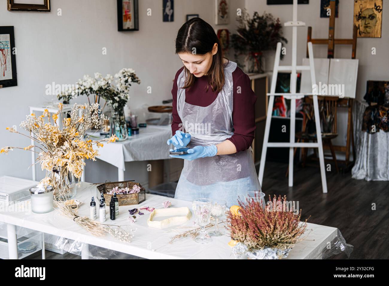 Creating beautiful epoxy resin art at a DIY studio with floral elements ...