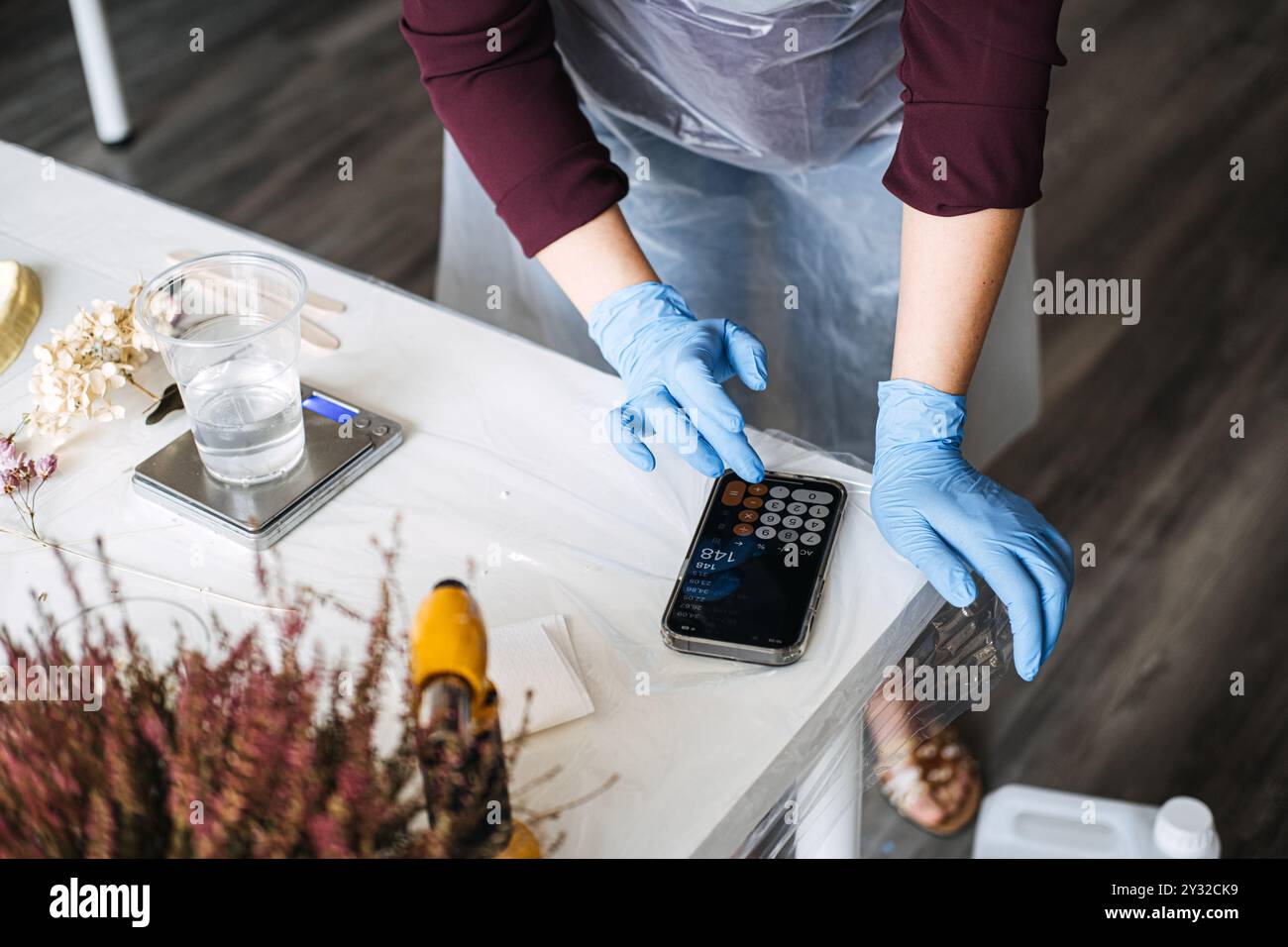 Crafting process with precise measurements, artisan calculating resin ...