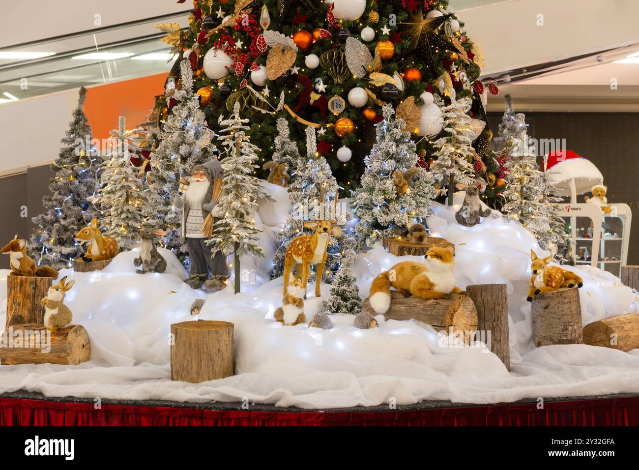 A Christmas installation with Santa and forest animals at the foot of a ...