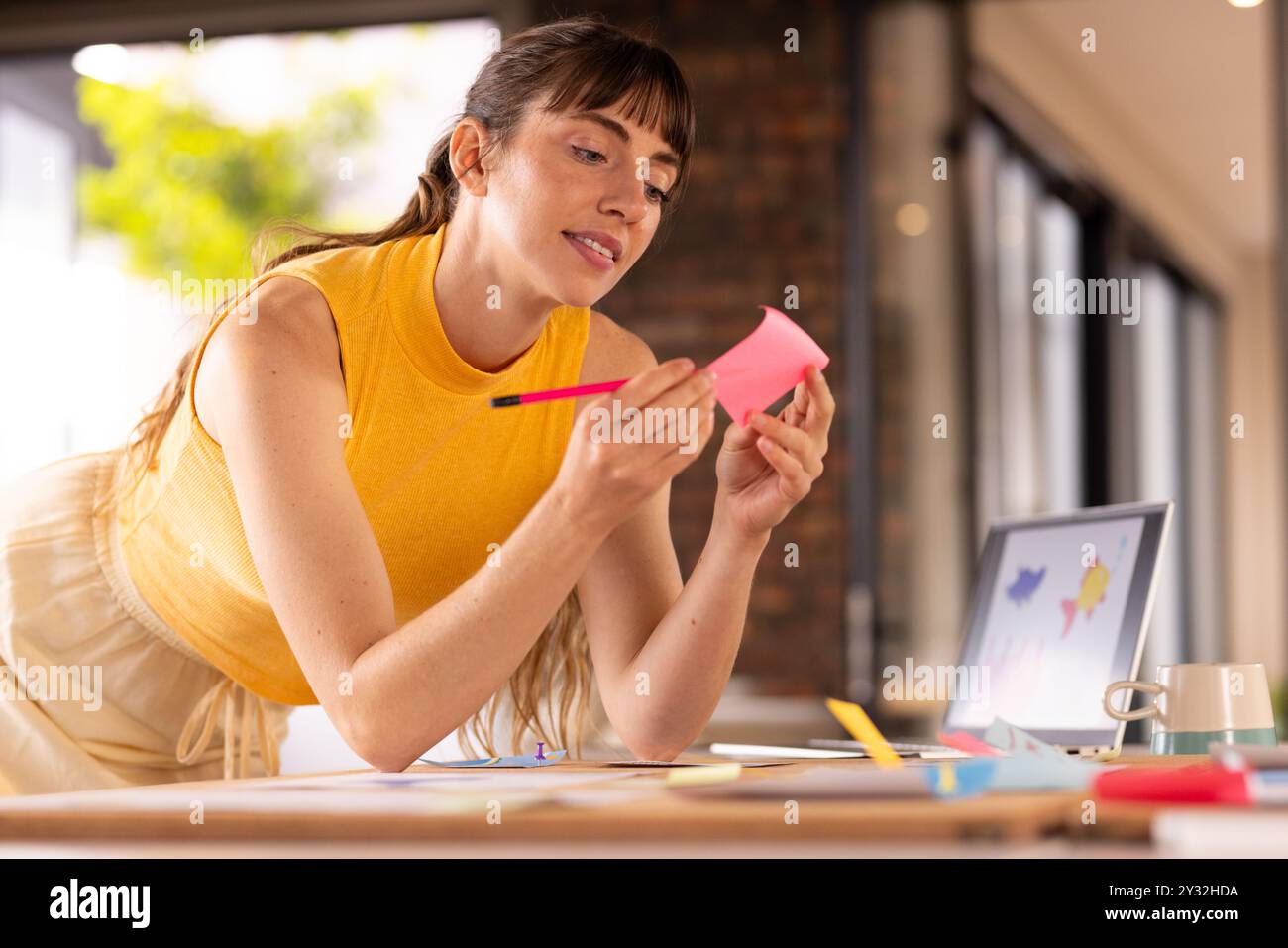 At office, Writing on sticky notes, woman brainstorming ideas for ...