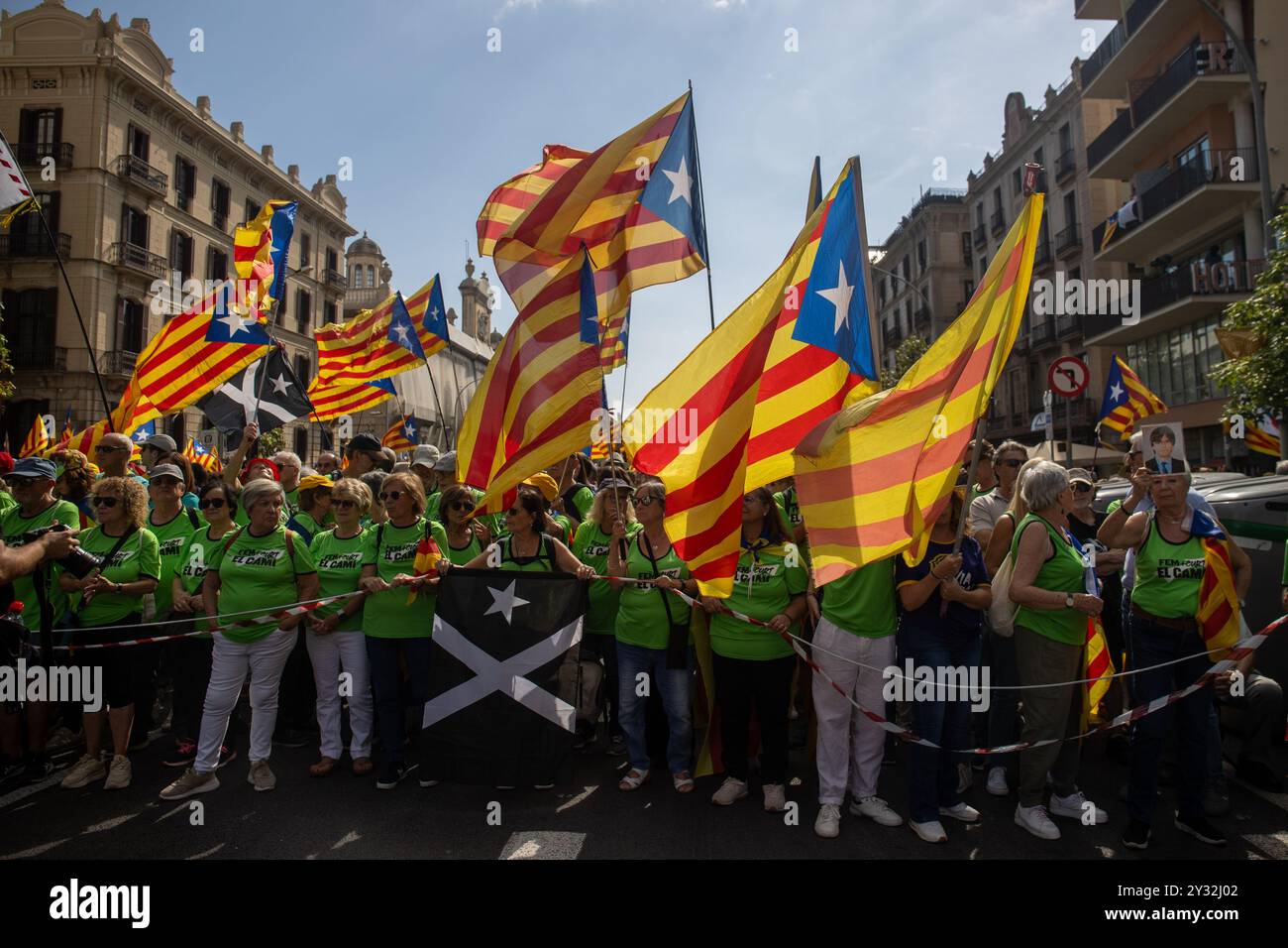 Pro-independence protesters carry "esteladas" flags during a ...