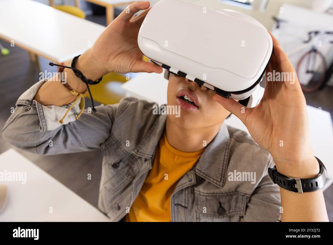Using VR headset, asian teenage boy exploring virtual reality in school ...