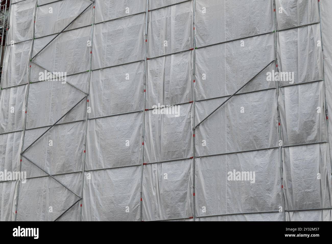 Gray tarpaulin and scaffolding. Building renovation and repair ...