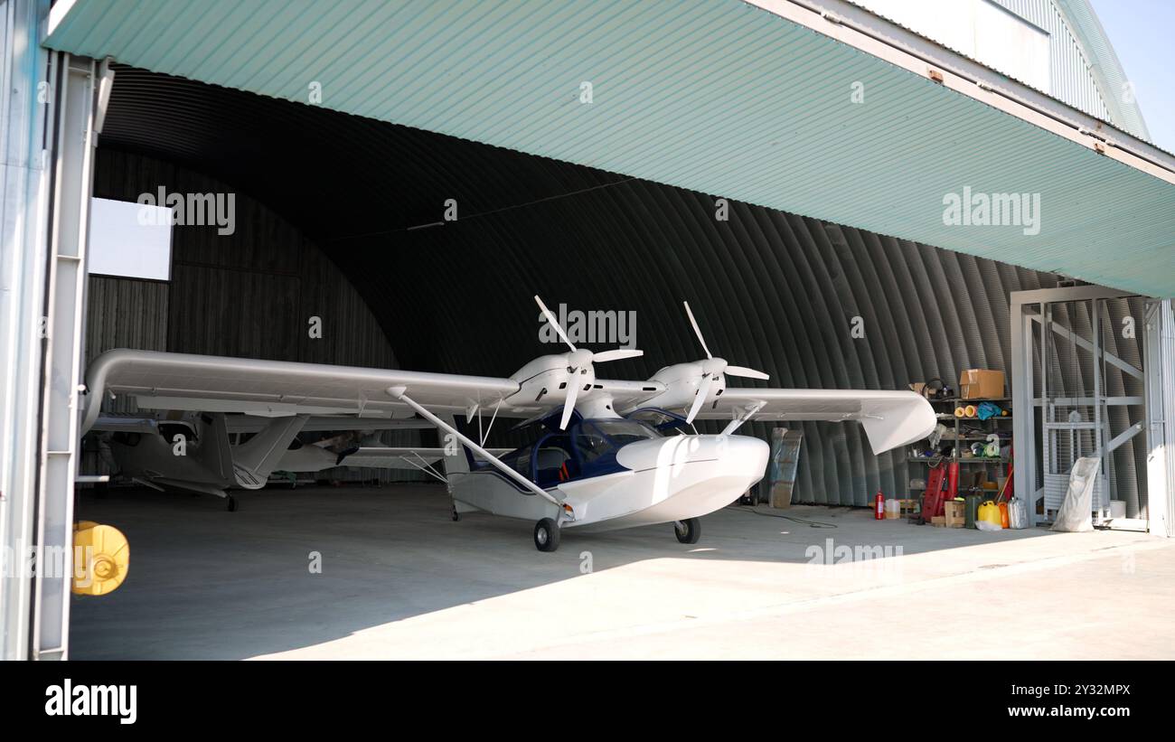 Airplane in hangar. Commercial aircraft in a hangar. Skydiving concept ...
