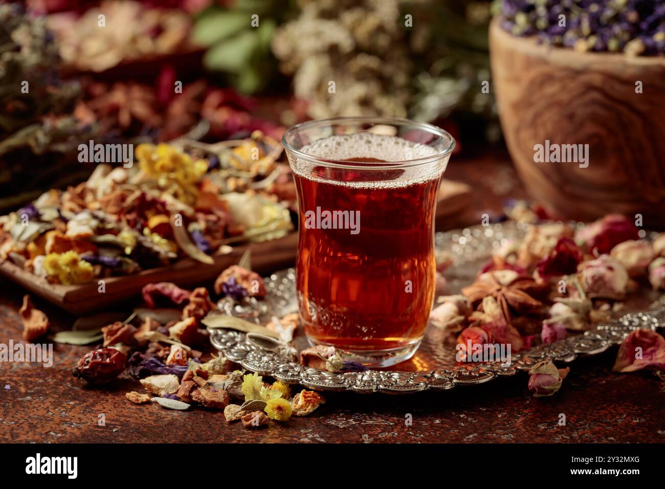 Herbal tea and a mix of various dried medicinal plants and herbs on a ...