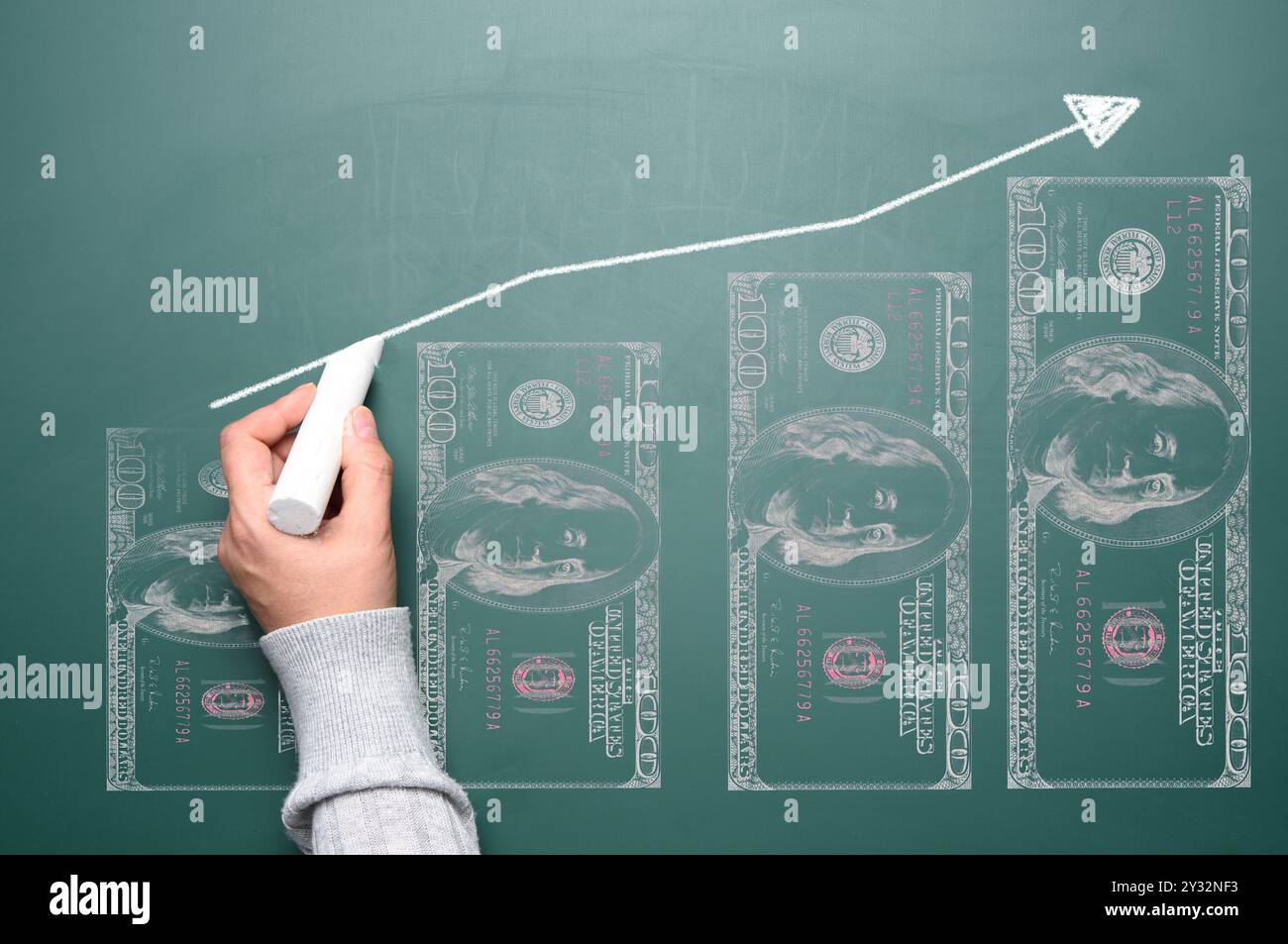 Female hand drawing a graph with increasing numbers on a green school ...