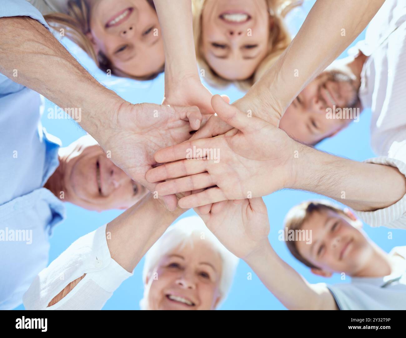 Happy, huddle and smile with hands of family for support, summer holiday and love. Low angle ...