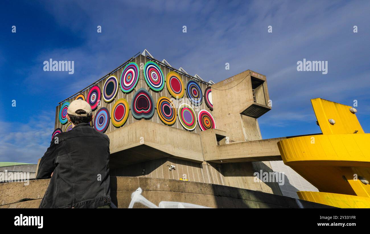 London, UK. 12th Sep, 2024. A member of staff poses with the work ...