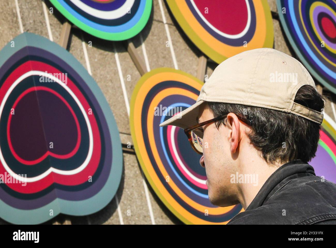 London, UK. 12th Sep, 2024. A member of staff poses with the work ...