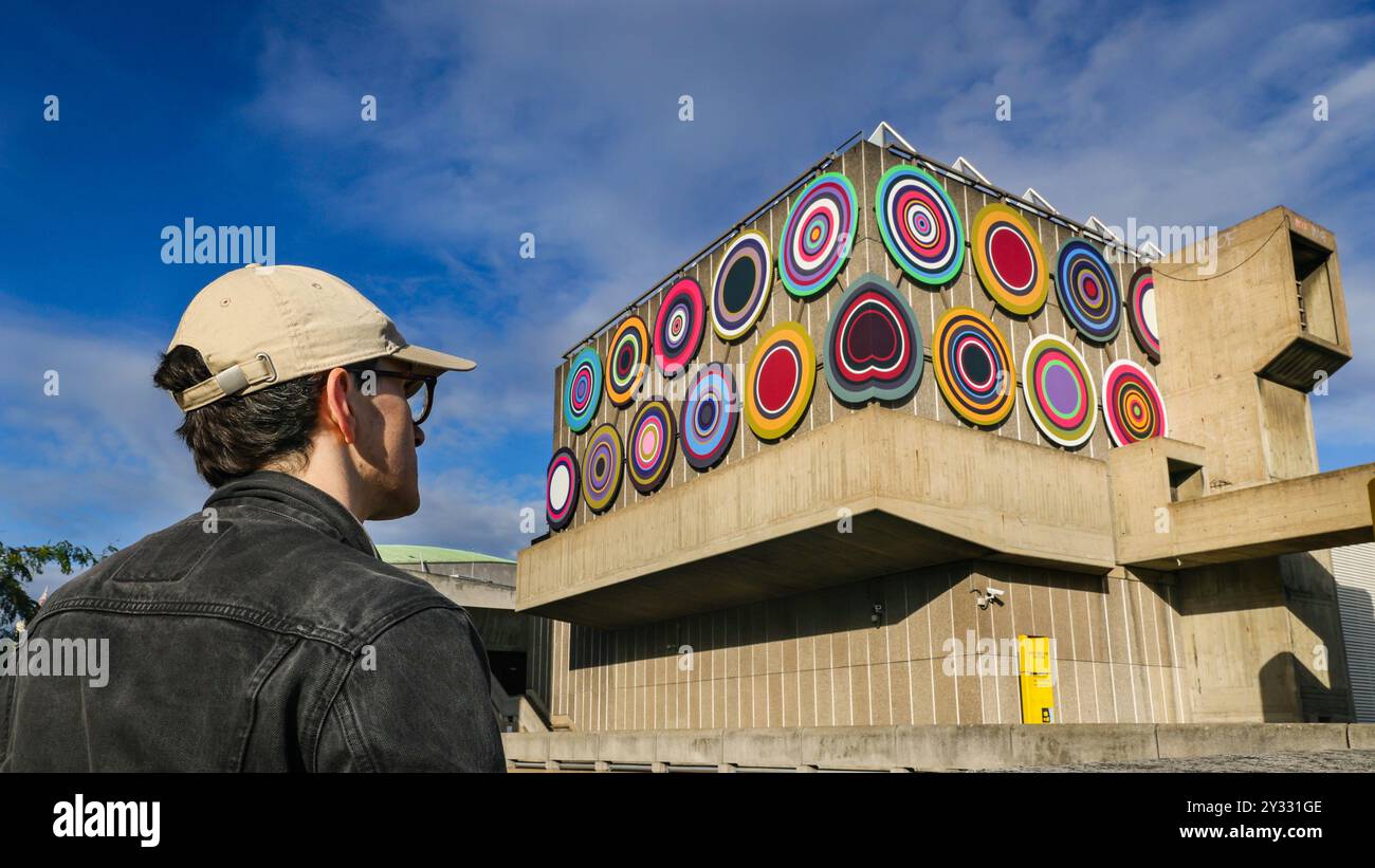 London, UK. 12th Sep, 2024. A member of staff poses with the work ...