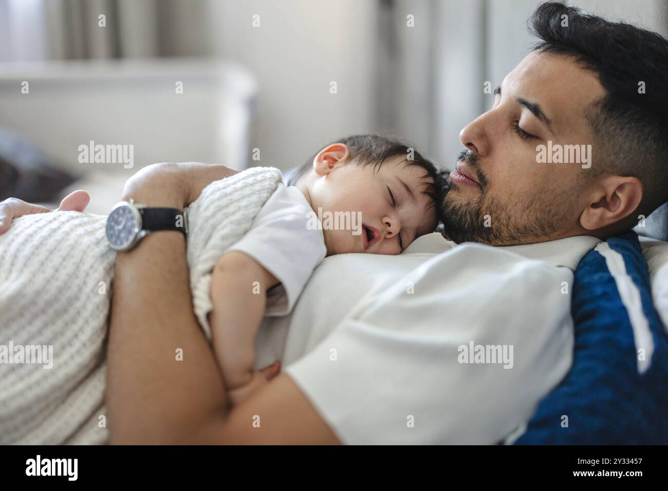 Young father and his baby sleeping together in the bed at home Stock ...
