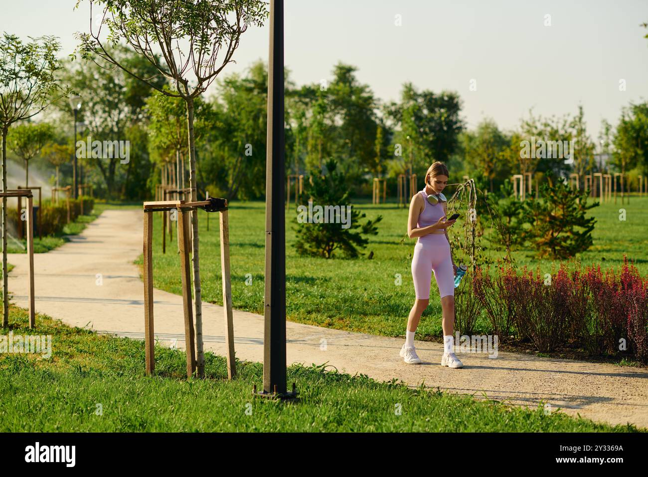 Woman strolls through park enjoying hi-res stock photography and images ...