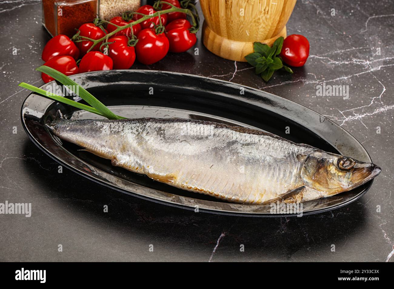 Whole raw salted herring fish in the plate Stock Photo - Alamy