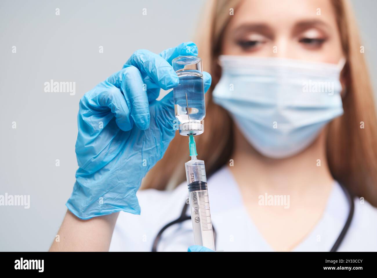 Health worker preparing vaccine, doctor drawing medicine into syringe ...