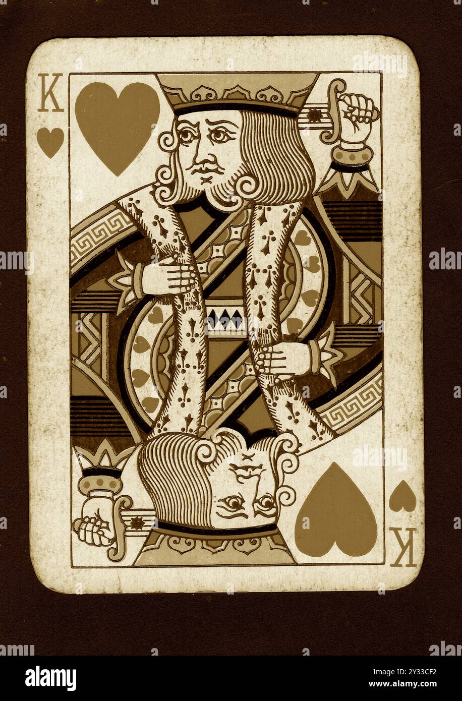 A vintage king of hearts playing card in sepia on a black background ...