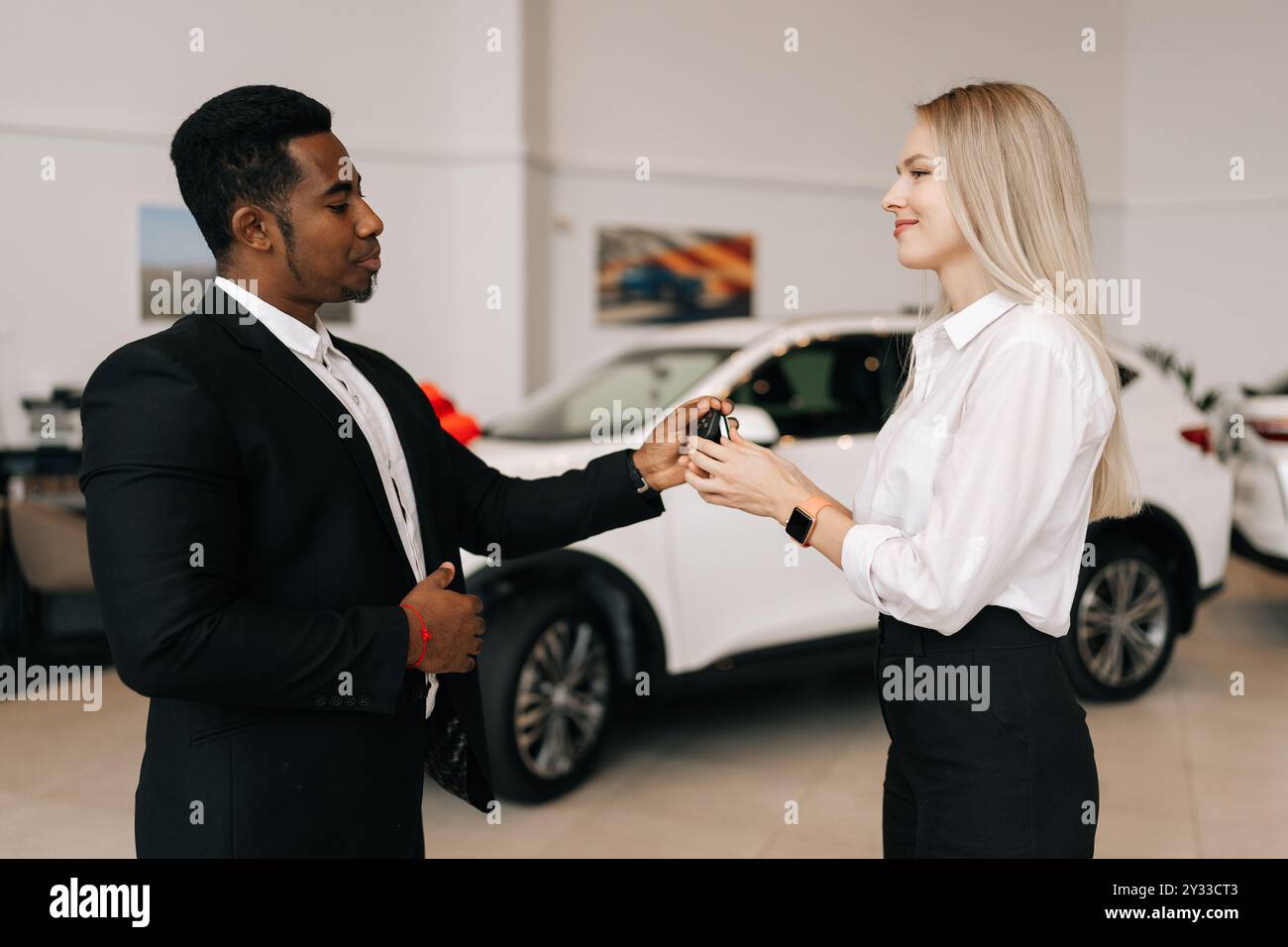 Side view of black salesman and female buyer shaking hands after ...