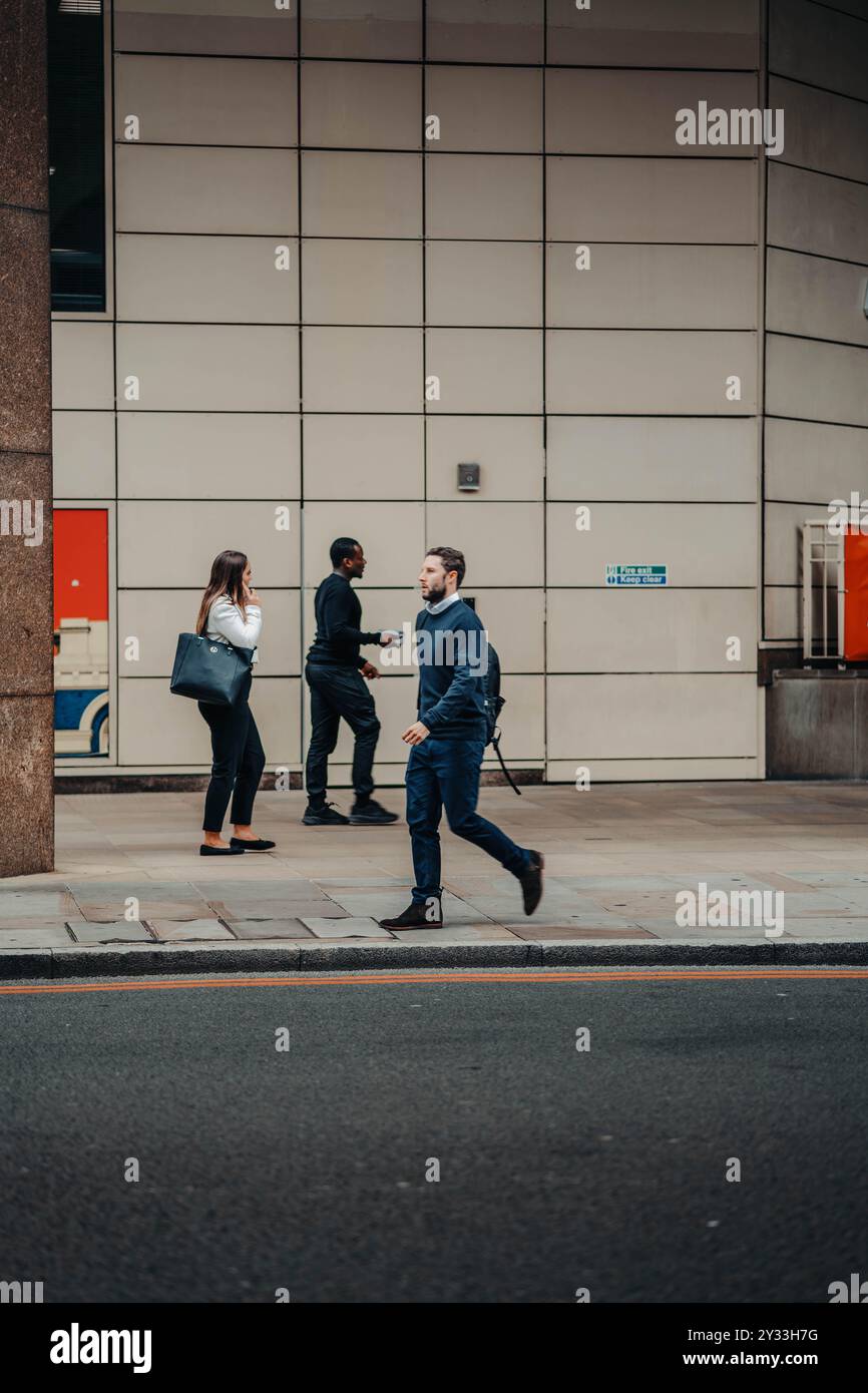 Man walking down street outside station in London, UK Stock Photo - Alamy